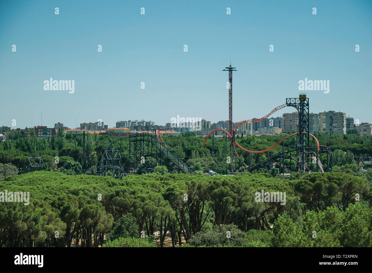 Roller coaster in amusement park with trees seen from the Teleferico ...
