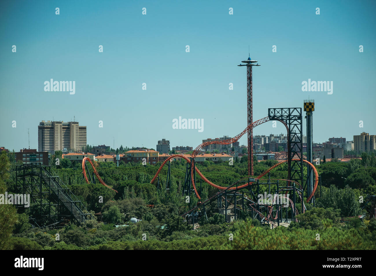 Roller coaster in amusement park with trees seen from the Teleferico ...
