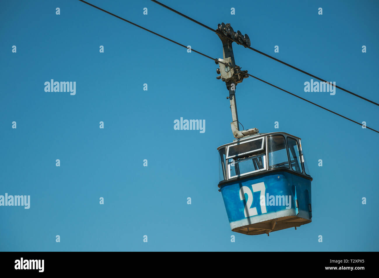 Cable car gondola passing through blue sky at the Teleferico Park of ...