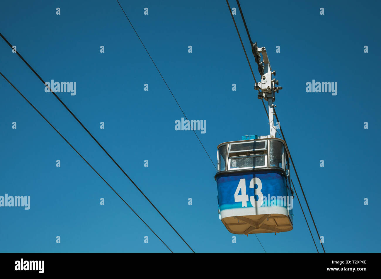 Cable car gondola passing through blue sky at the Teleferico Park of ...
