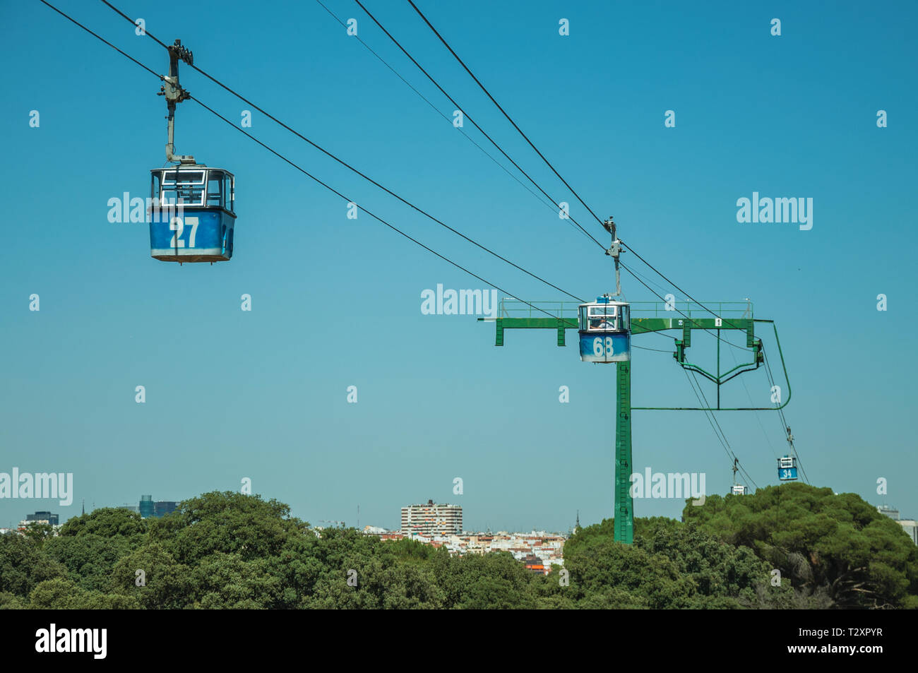 Cable car gondola passing through big supporting towers at the ...