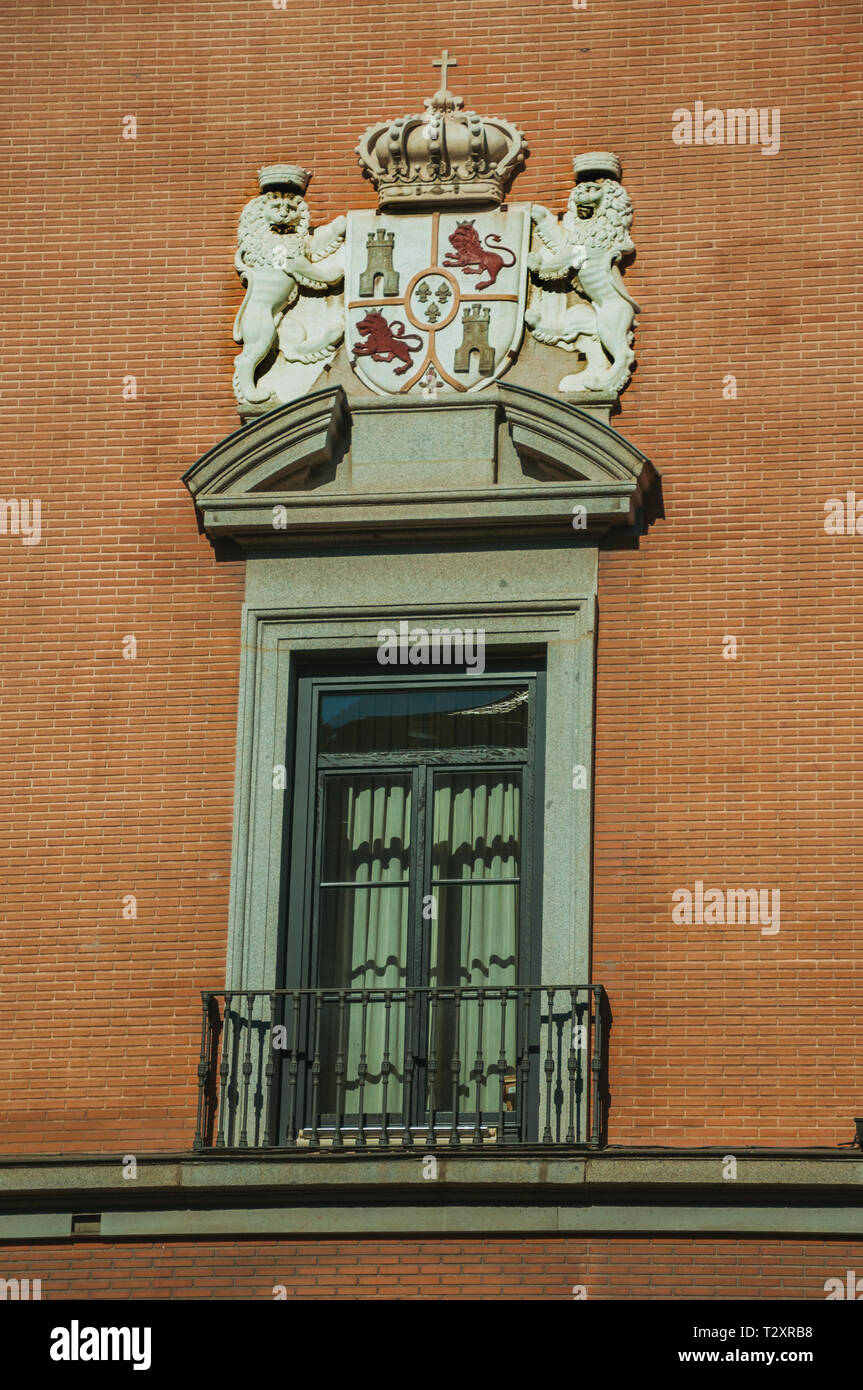 Glazed window with balustrade and luxurious carved decoration on bricks ...