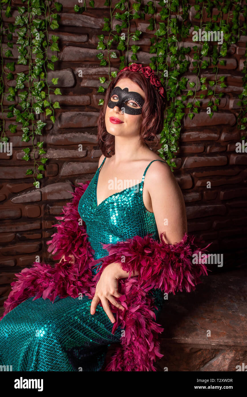 A woman in a green dress and green mask at a masquerade ball Stock ...