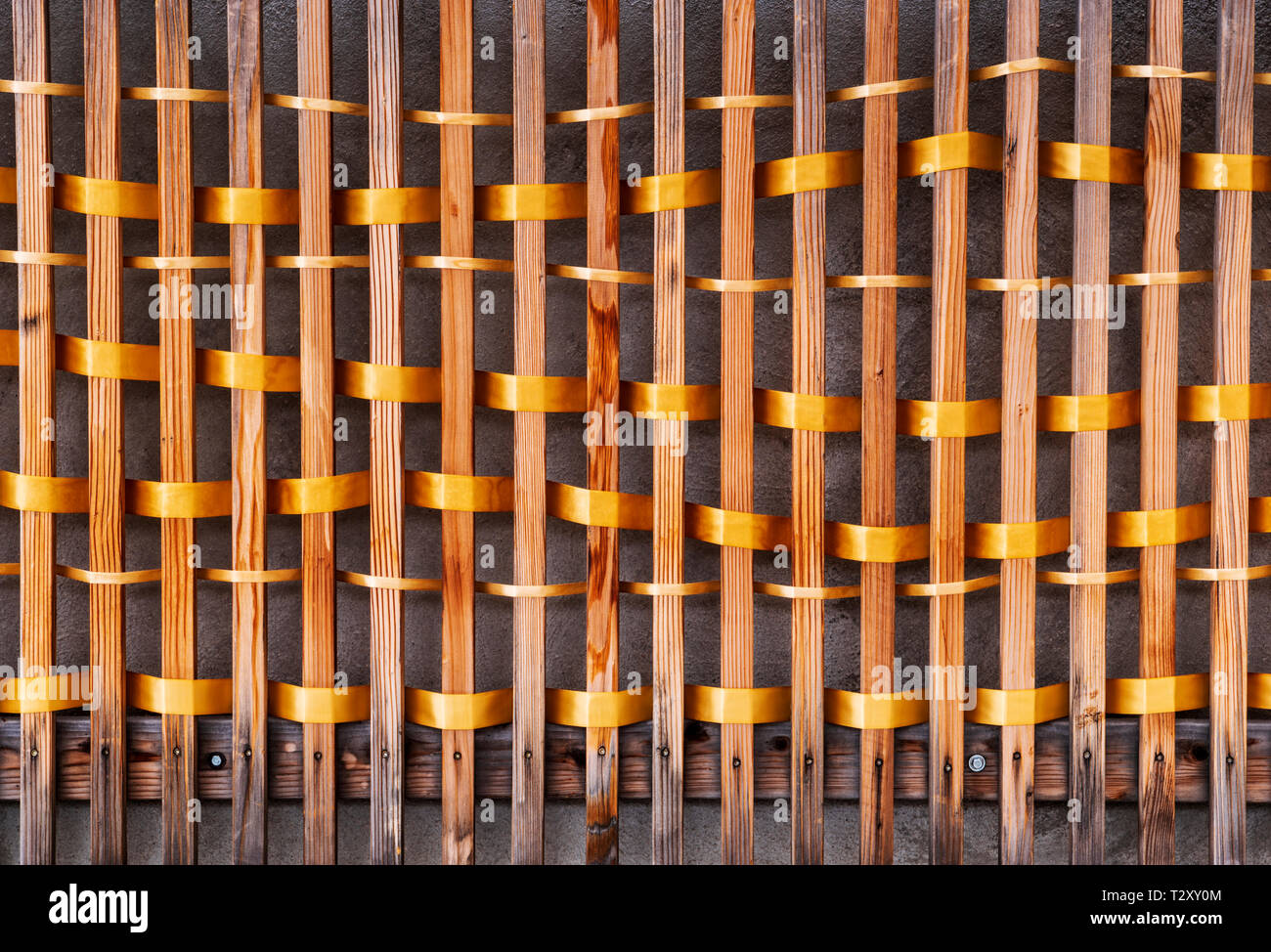 An unknown artist weaves golden ribbon through fence slats; Salida ...