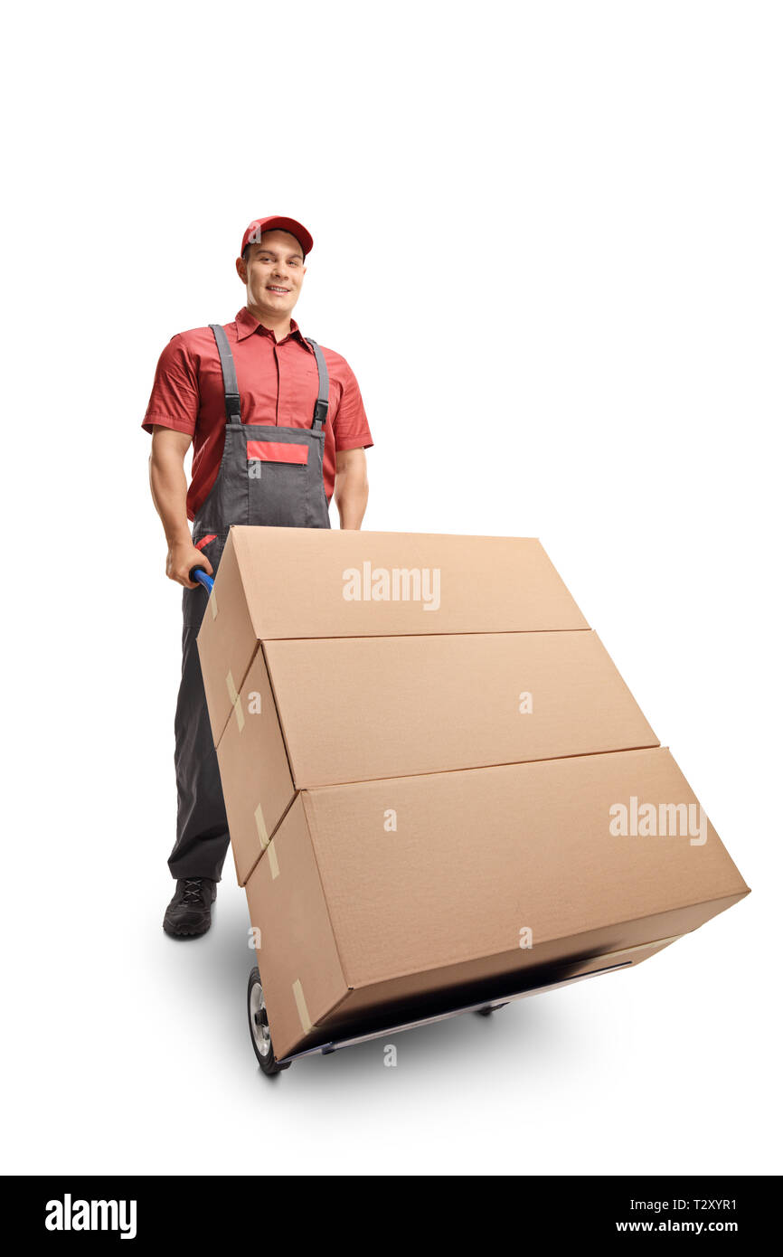 Male worker with a stack of boxes on a hand truck smiling at the camera ...