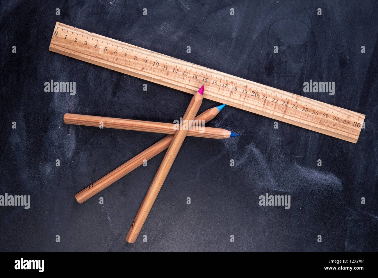 Wooden pencils and ruler on a blackboard Stock Photo - Alamy