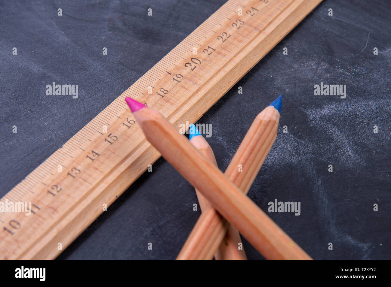 Wooden pencils and ruler on a blackboard Stock Photo - Alamy