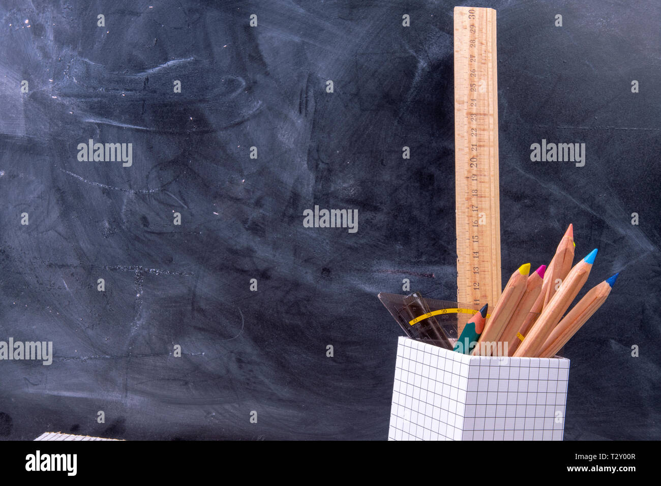 Colored pencils and ruler with blackboard Stock Photo - Alamy