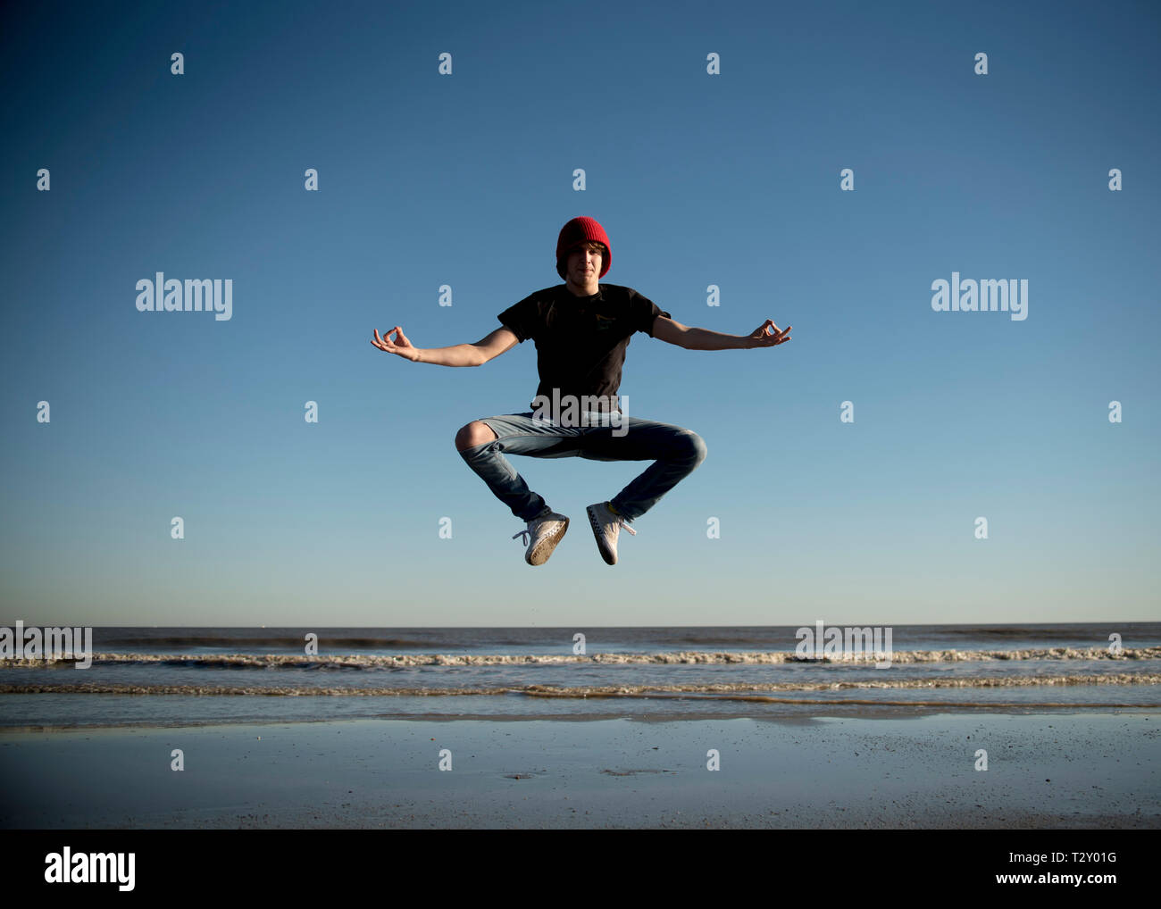 Happy teenage boy jumping for joy on Galveston, Texas beach Stock Photo ...