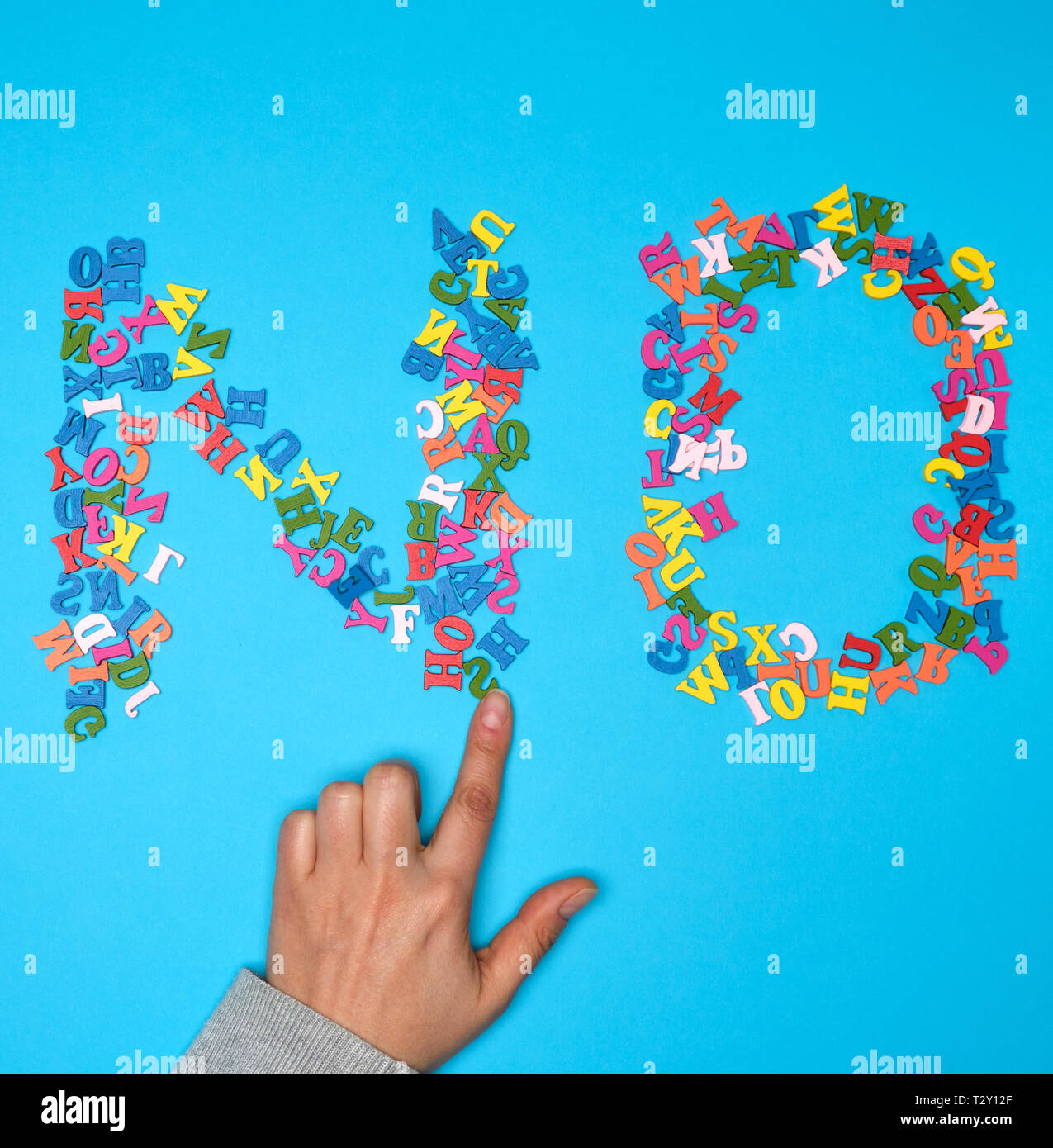 word no from multicolored small wooden letters on a blue background ...