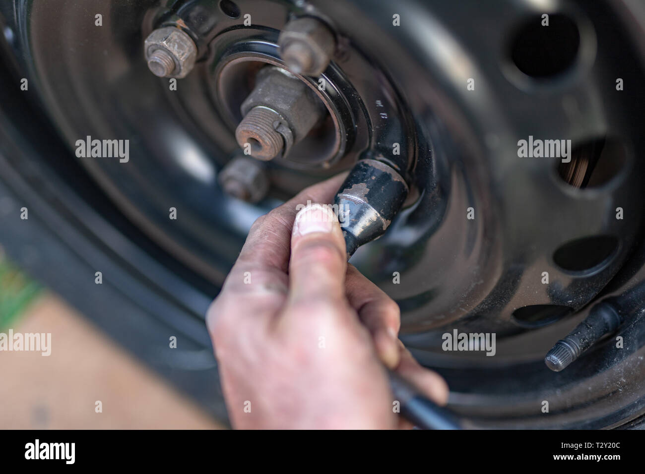 Replacing the wheel in a passenger car. Changing wheels from winter to ...