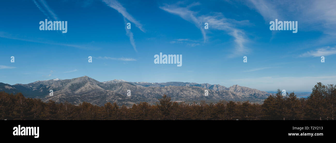 Mountain chain in front of a large forest Stock Photo - Alamy