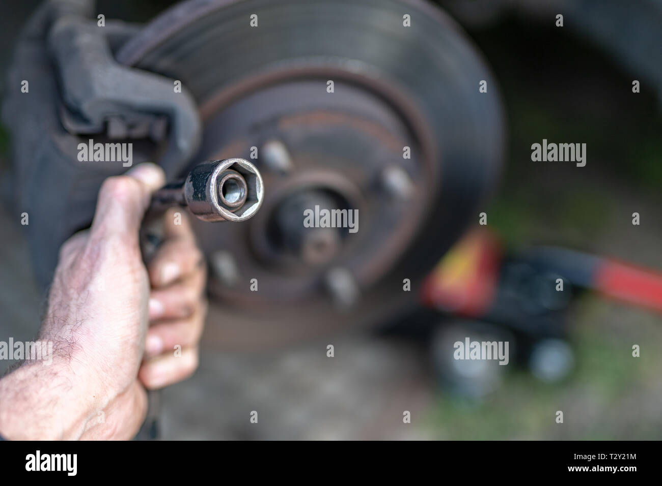 Replacing the wheel in a passenger car. Changing wheels from winter to ...