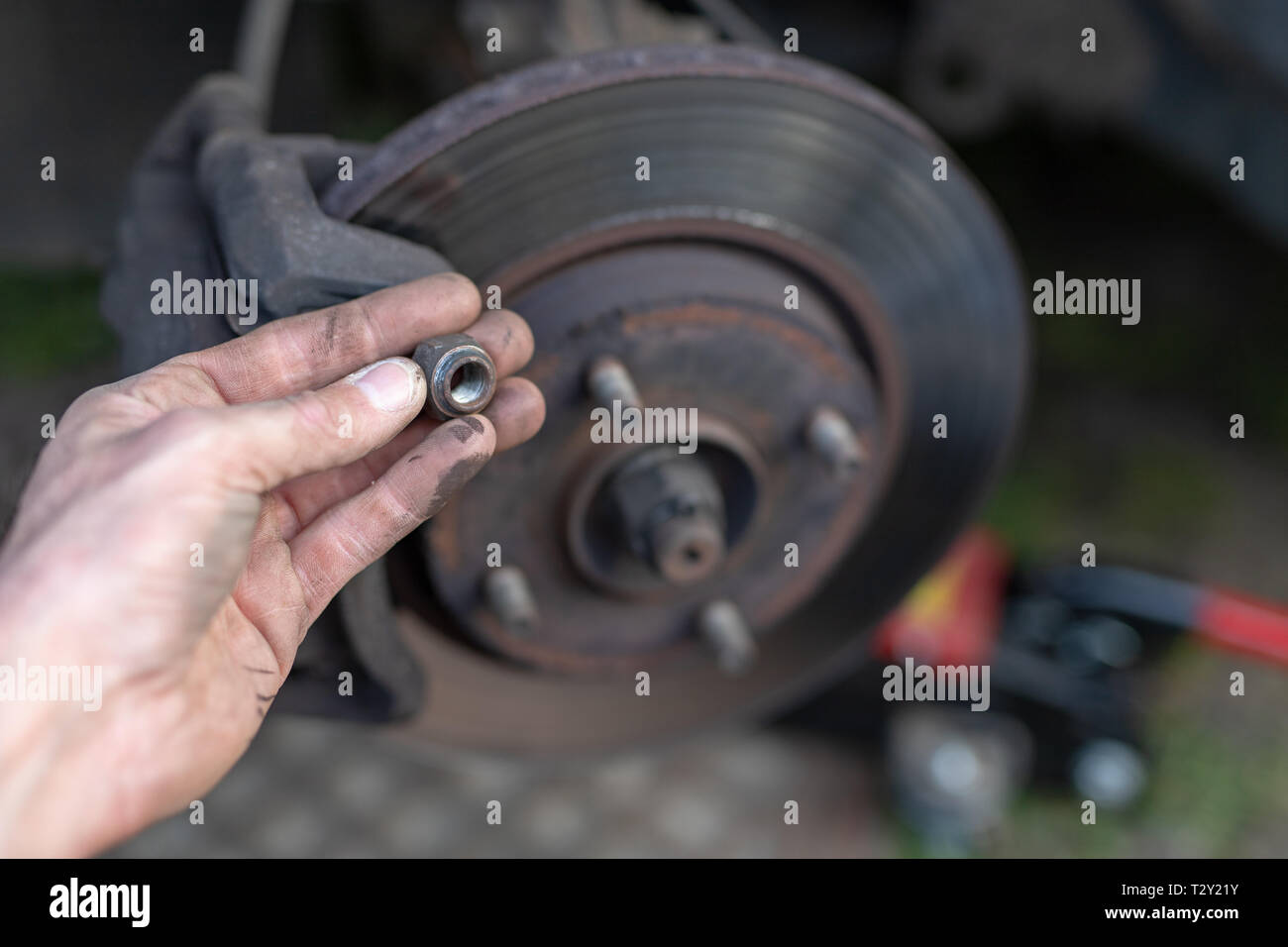 Replacing the wheel in a passenger car. Changing wheels from winter to ...