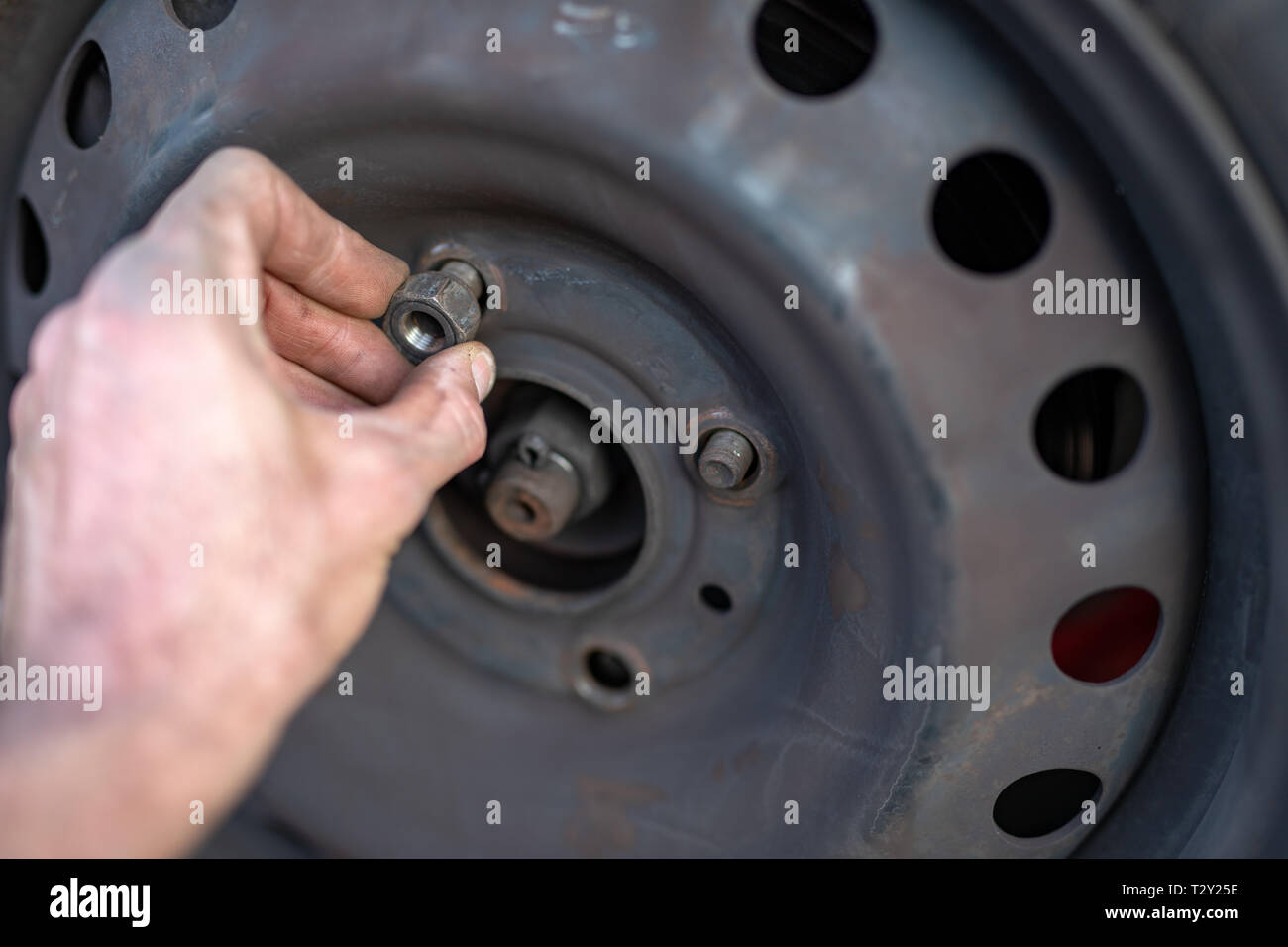 Replacing the wheel in a passenger car. Changing wheels from winter to ...