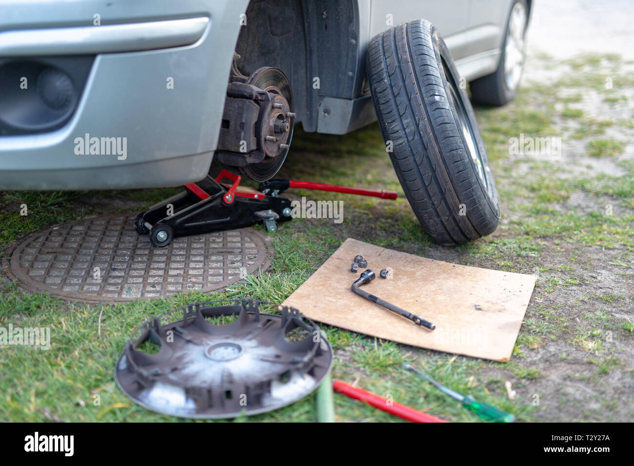Replacing the wheel in a passenger car. Changing wheels from winter to ...