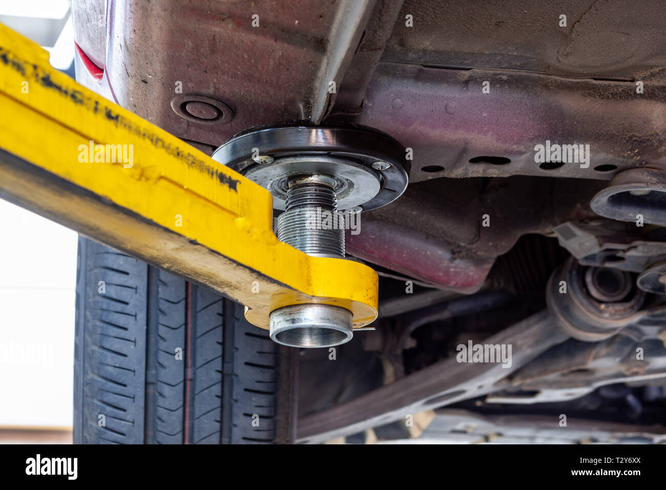 Closeup of hydraulic car lift arm holding a vehicle Stock Photo - Alamy