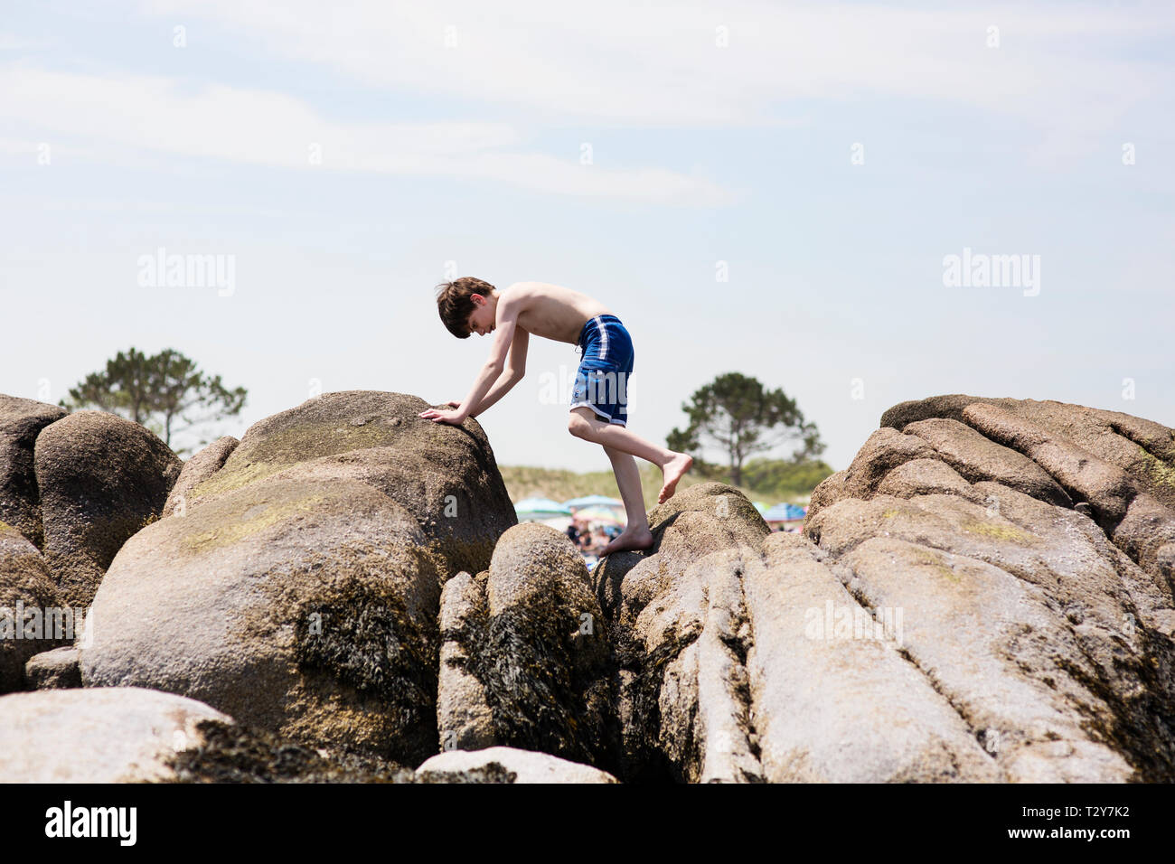 Kid climbing on rocks hi-res stock photography and images - Alamy
