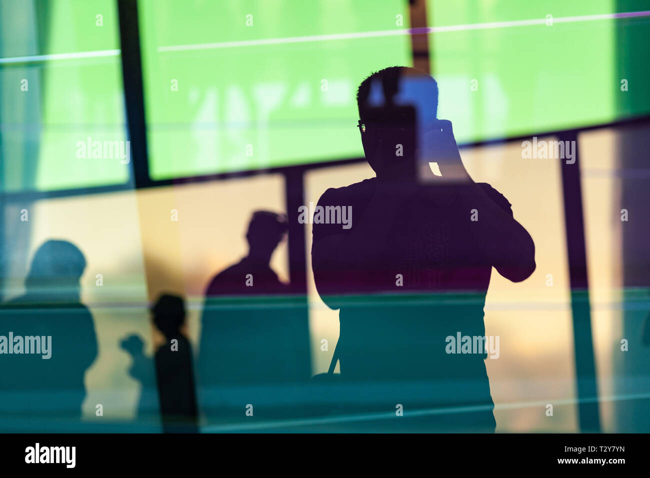 People silhouettes reflecting in tall windows of modern building Stock ...