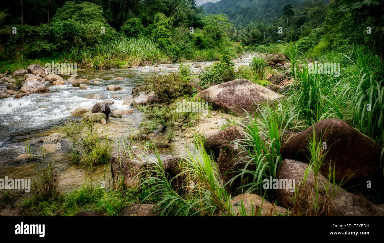 Small rapids on river flowing through the mountains in Kiriwong ...