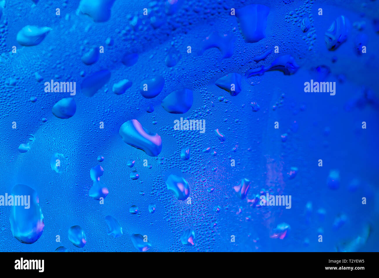 Random water drops on glass surface with blue light background Stock ...