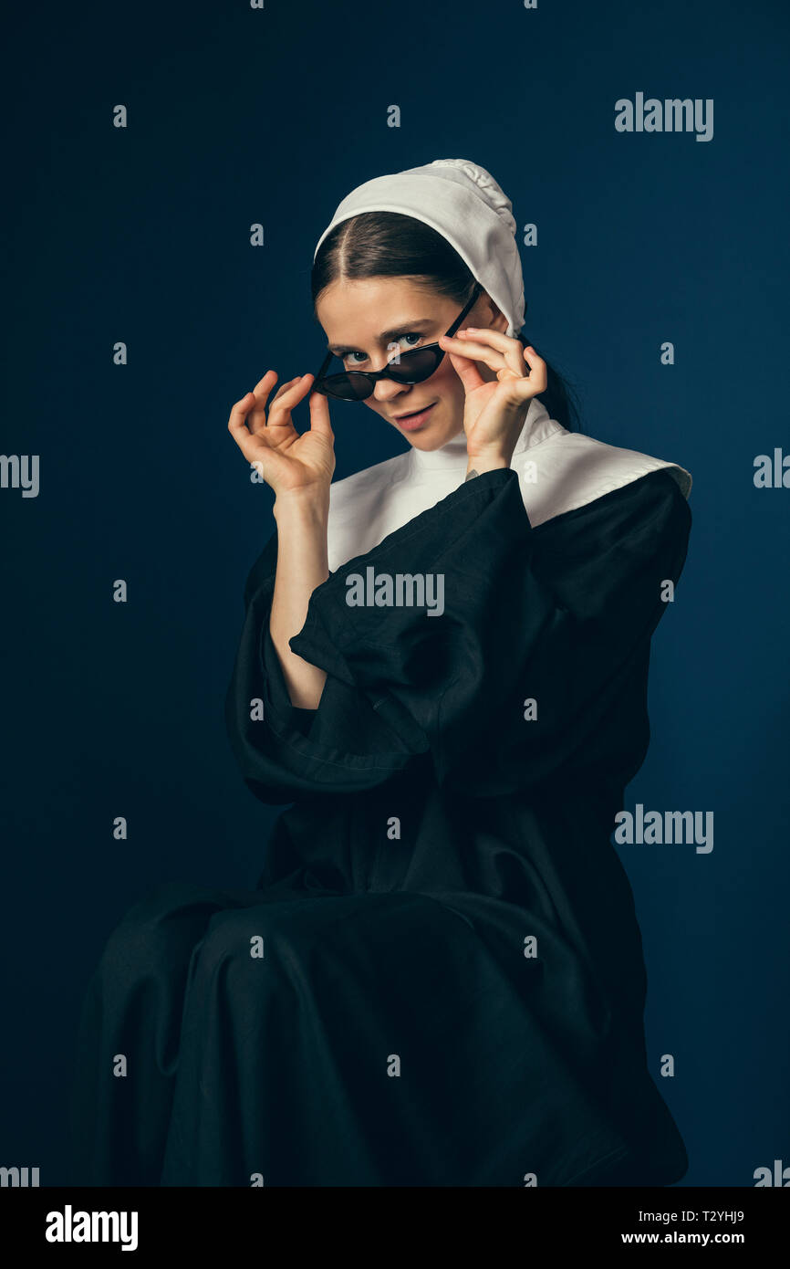 Modern view of old rules. Medieval young woman as a nun in vintage ...