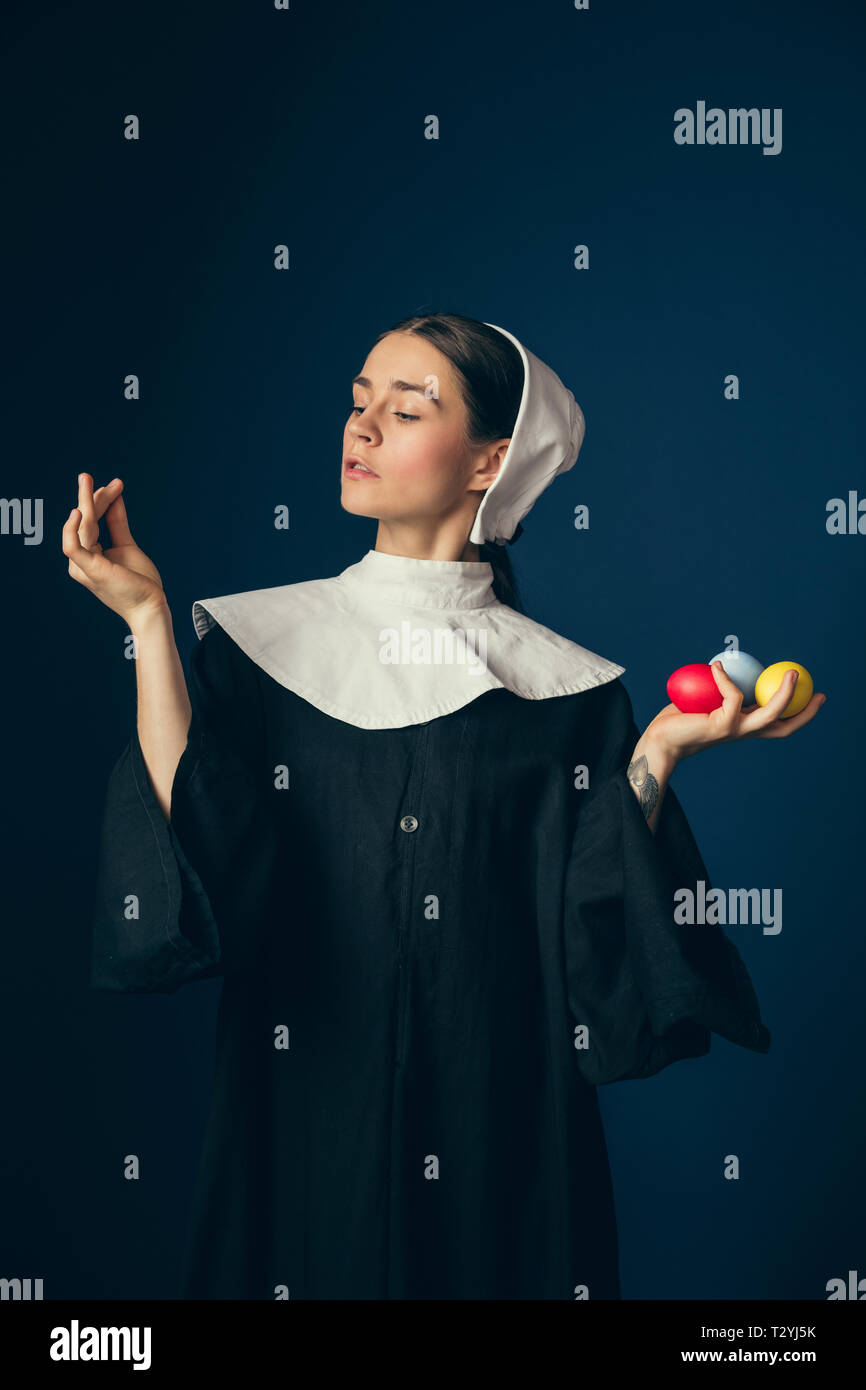 Easter mood. Medieval young woman as a nun in vintage clothing and ...