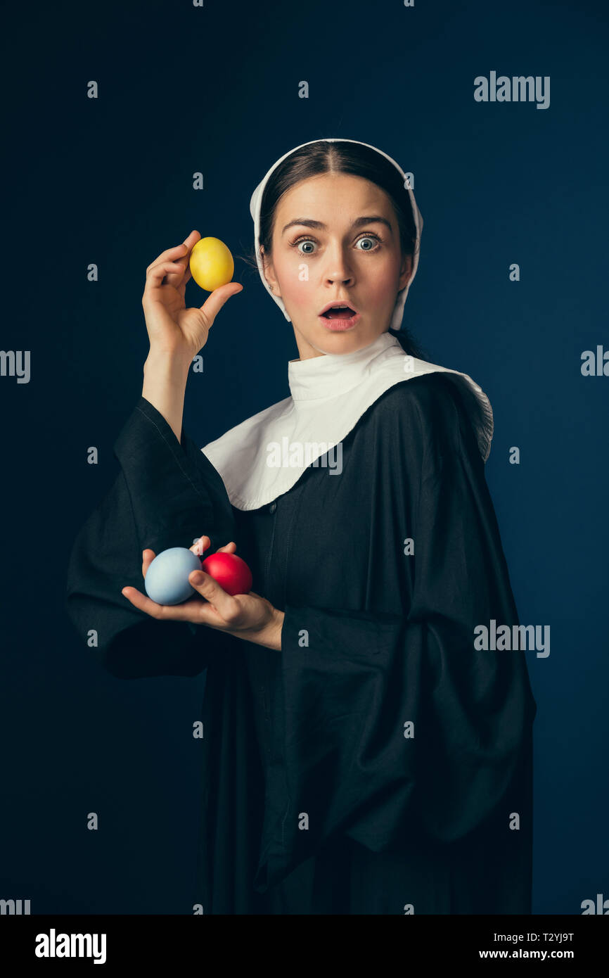 Easter is coming soon. Medieval young woman as a nun in vintage ...