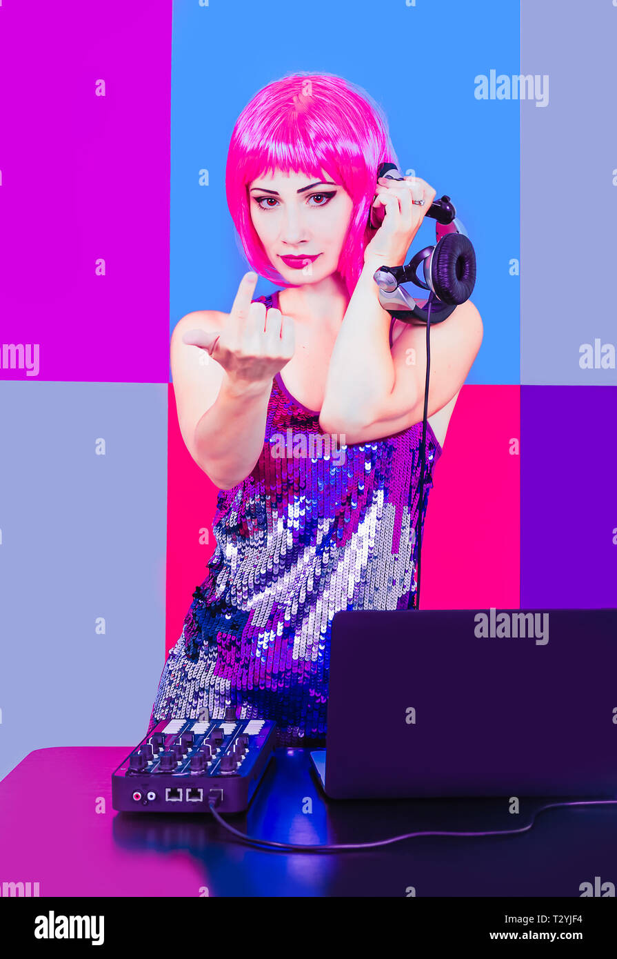 Glamorous DJ girl with pink hair and headphne on red, pink and blue ...