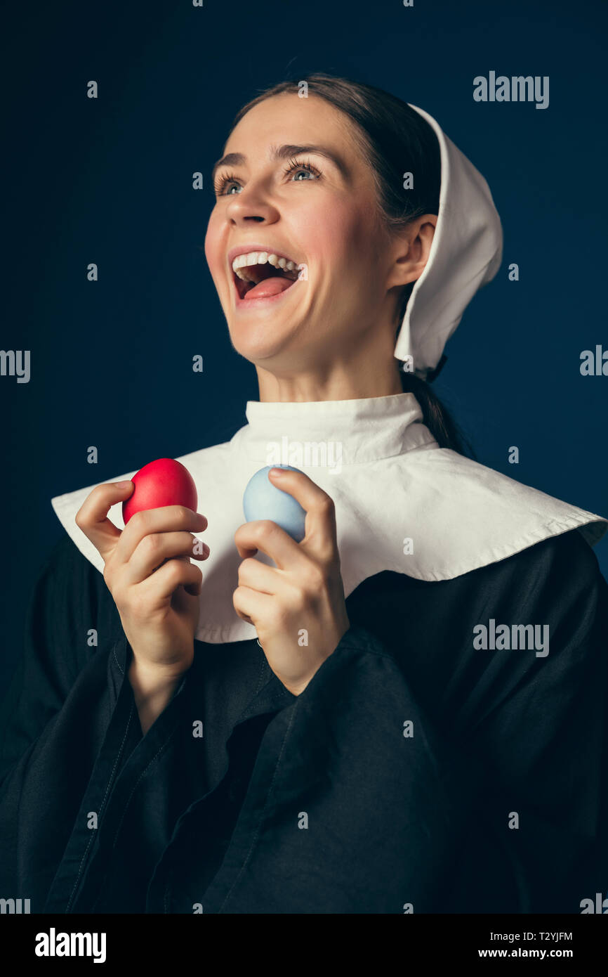 Emotions of happiness. Medieval young woman as a nun in vintage ...