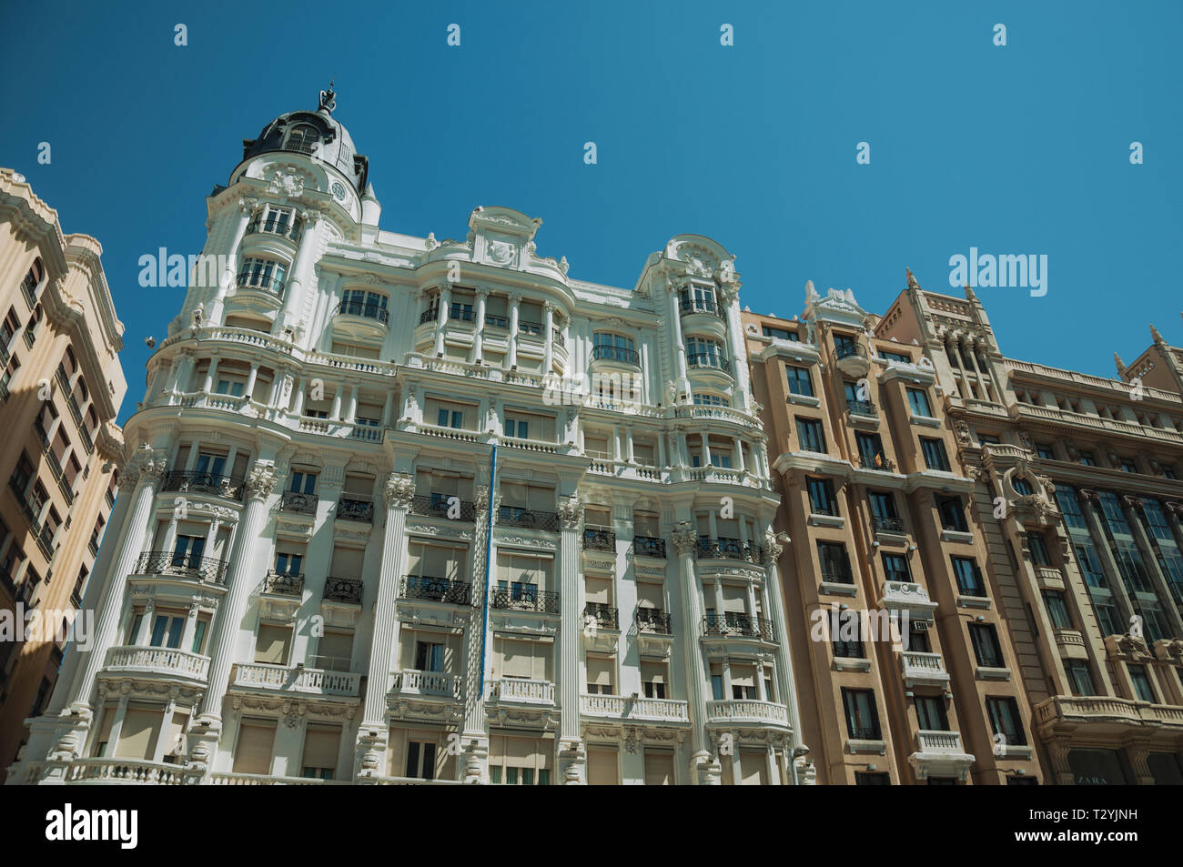 Facade with flamboyant decoration on old buildings full of windows in ...