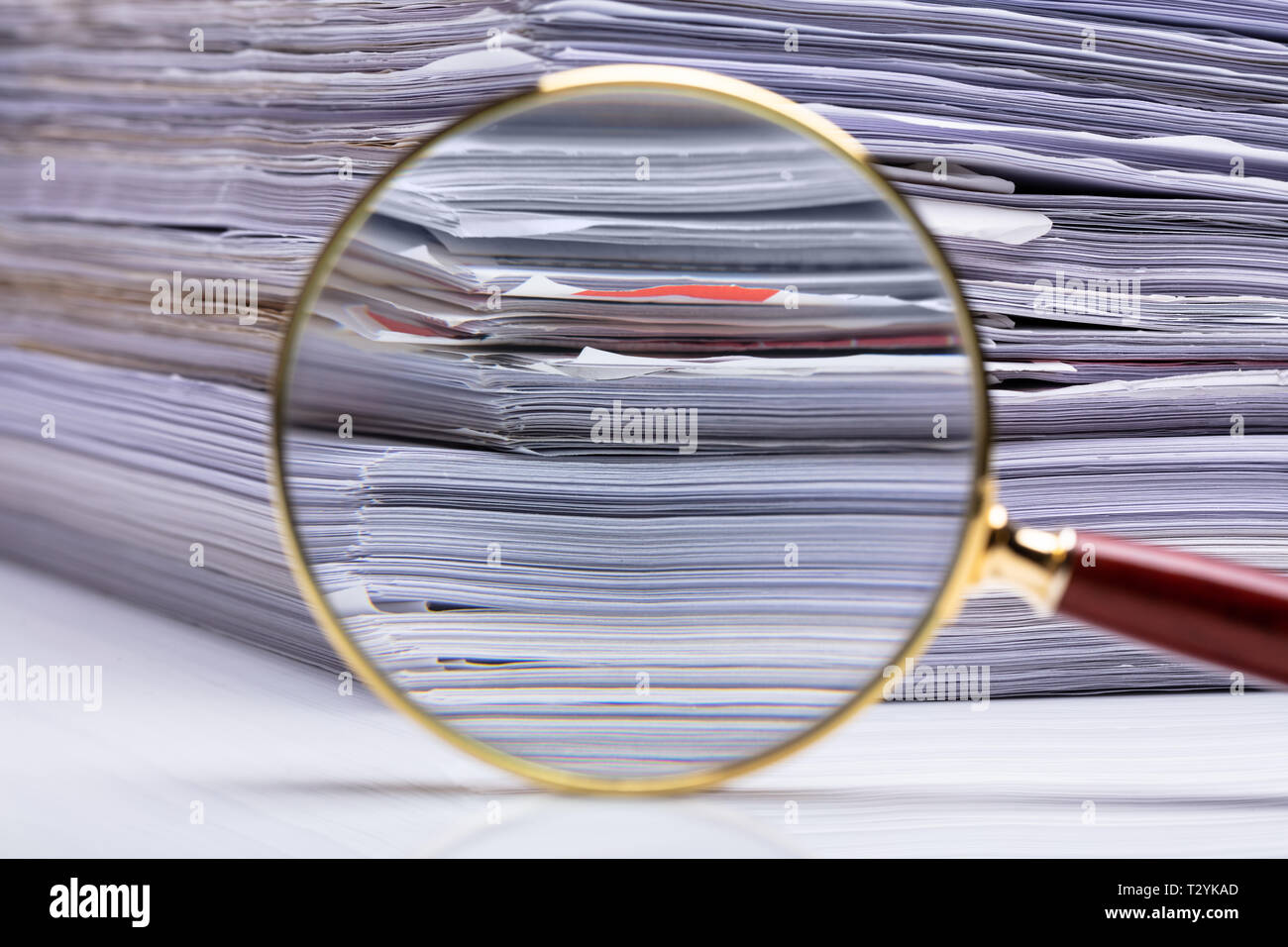 Close-up Of Magnifying Glass On Background Of The Stacked Paper Files ...