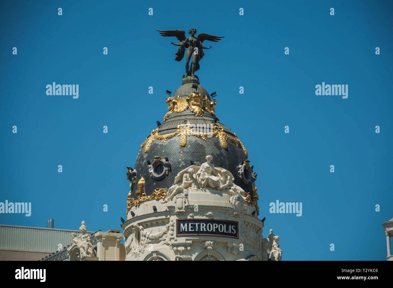 Flamboyant decoration on old building and golden dome with sculpture on ...