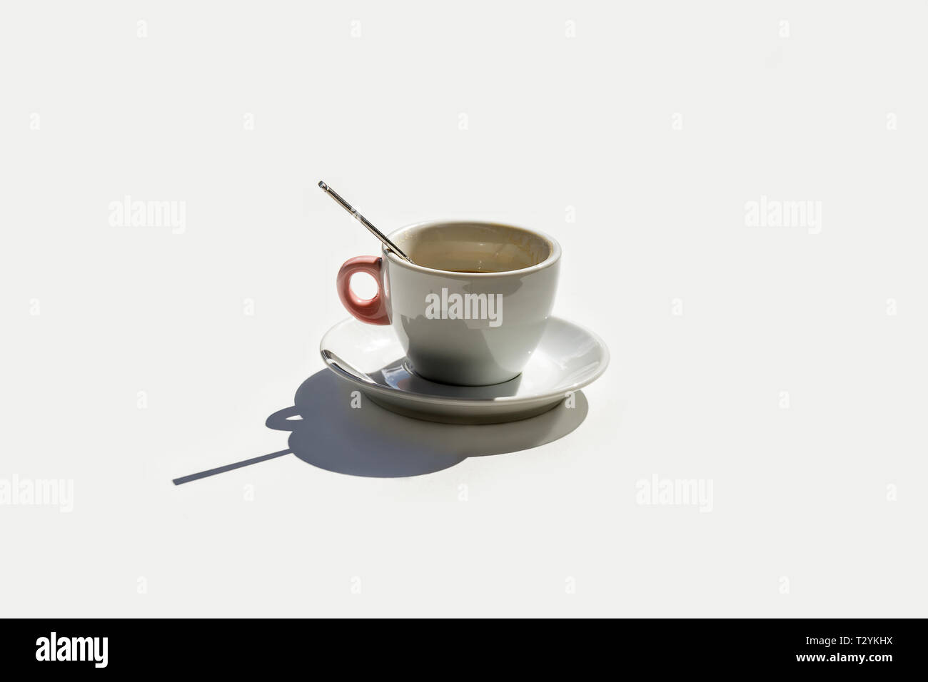 Cup of coffee on white background. Leaving coffee in a cup with a spoon ...