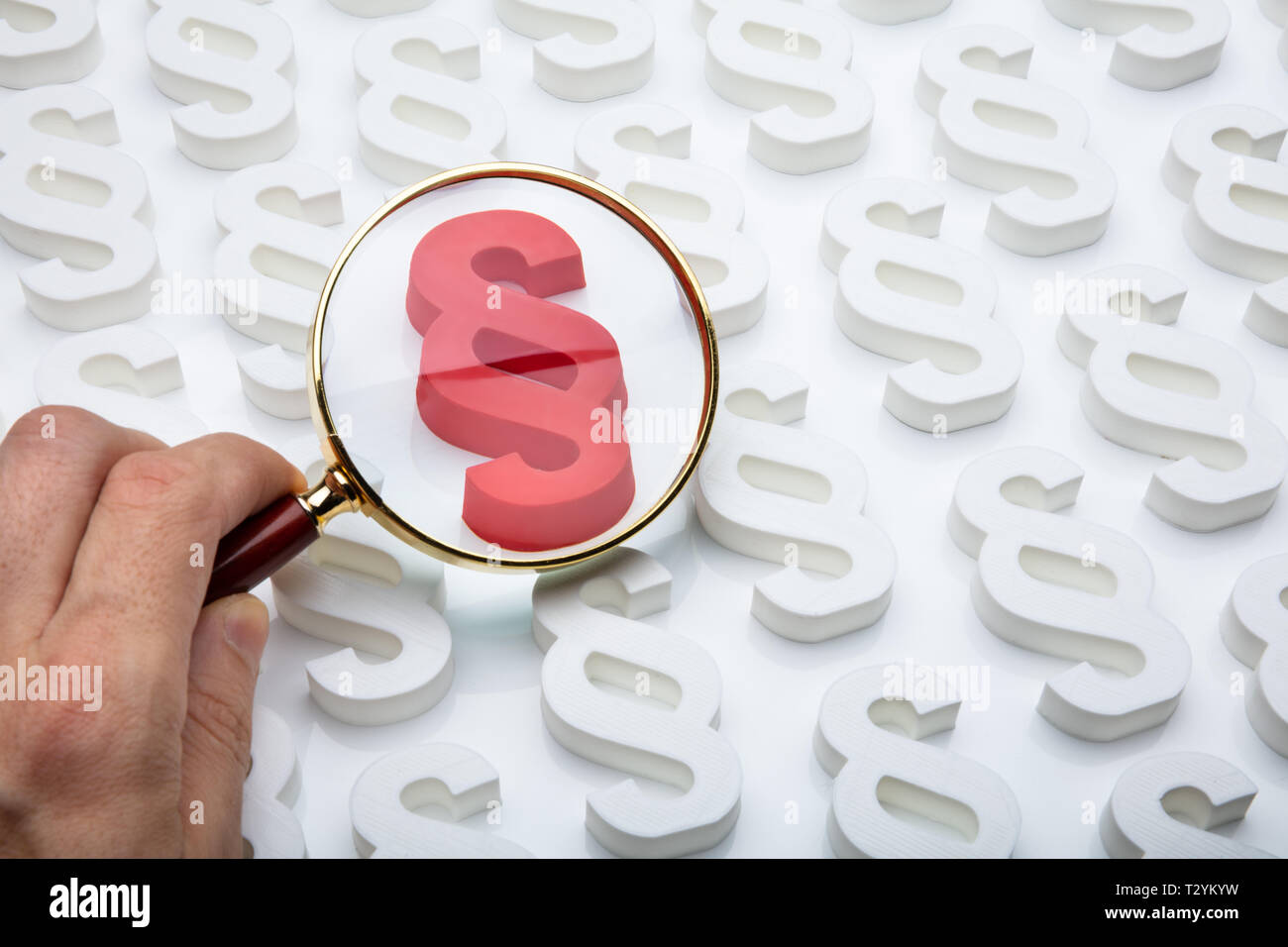 Close-up Of A Person Looking At Red Paragraph Symbol Through Magnifying ...