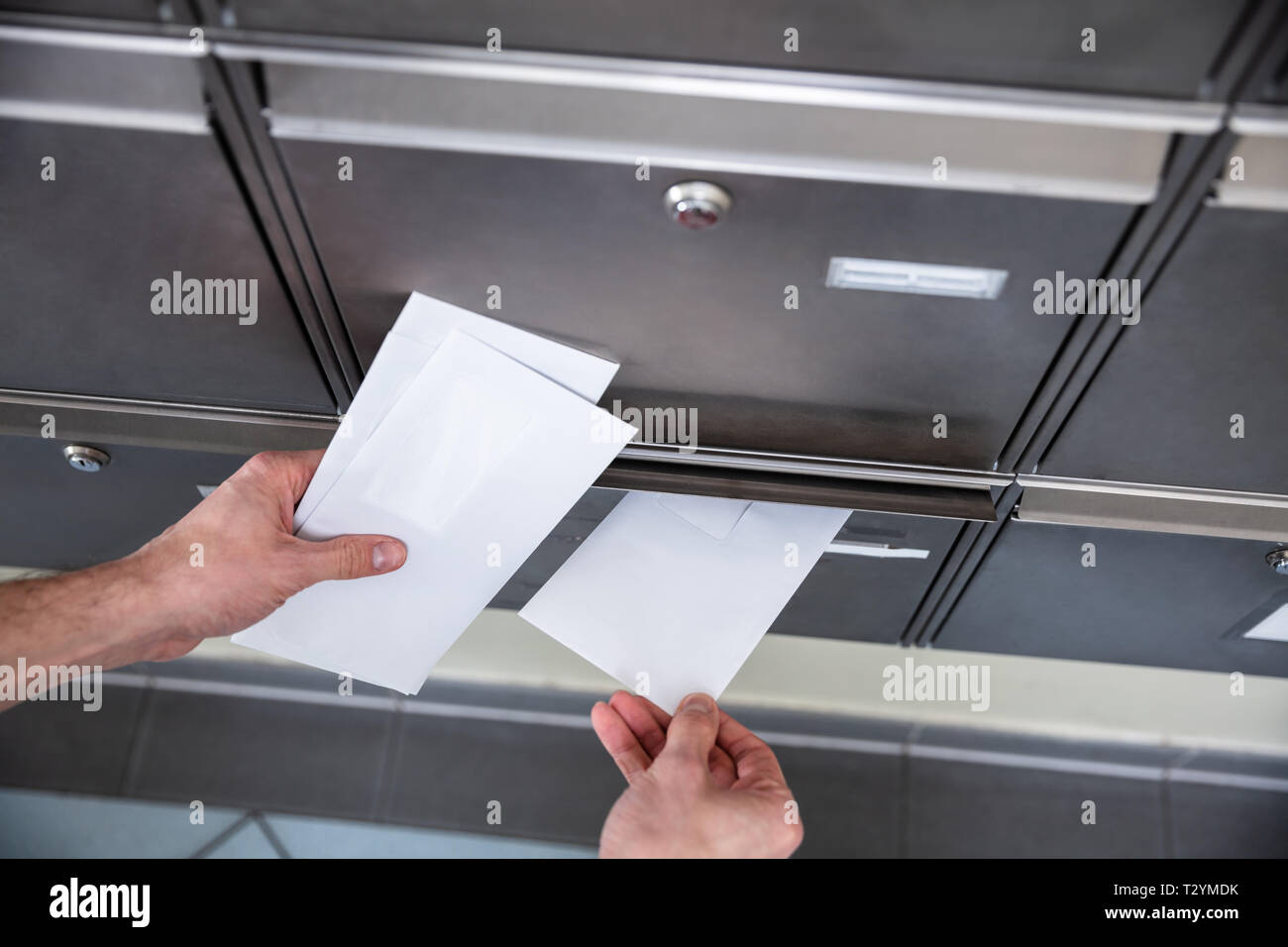 Close-up Of Man's Hand Inserting Letters In Mailbox Stock Photo - Alamy