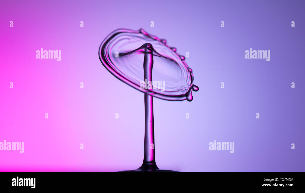 Close-up of a water drop falling on water surface Stock Photo - Alamy