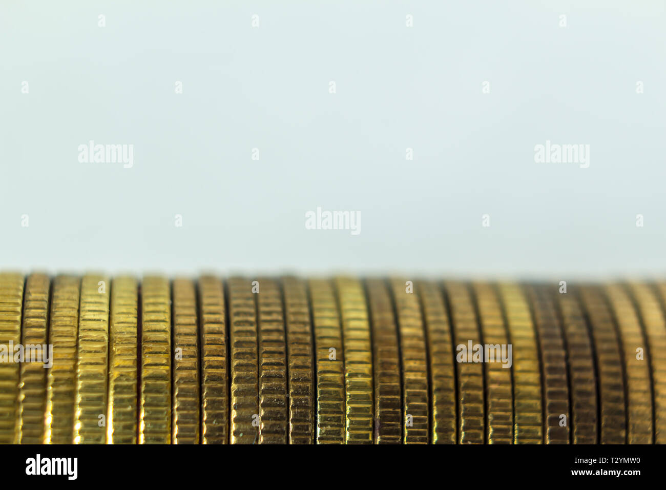 Macrophoto of a stack of coins. A stack of coins lies on its side. Side ...