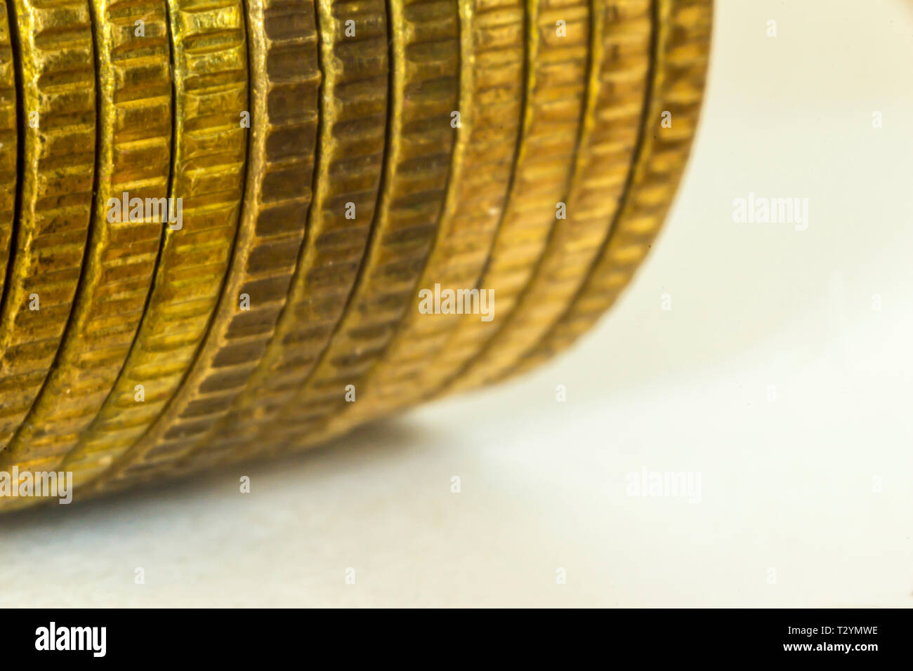 Macrophoto of a stack of coins. A stack of coins lies on its side. Side ...