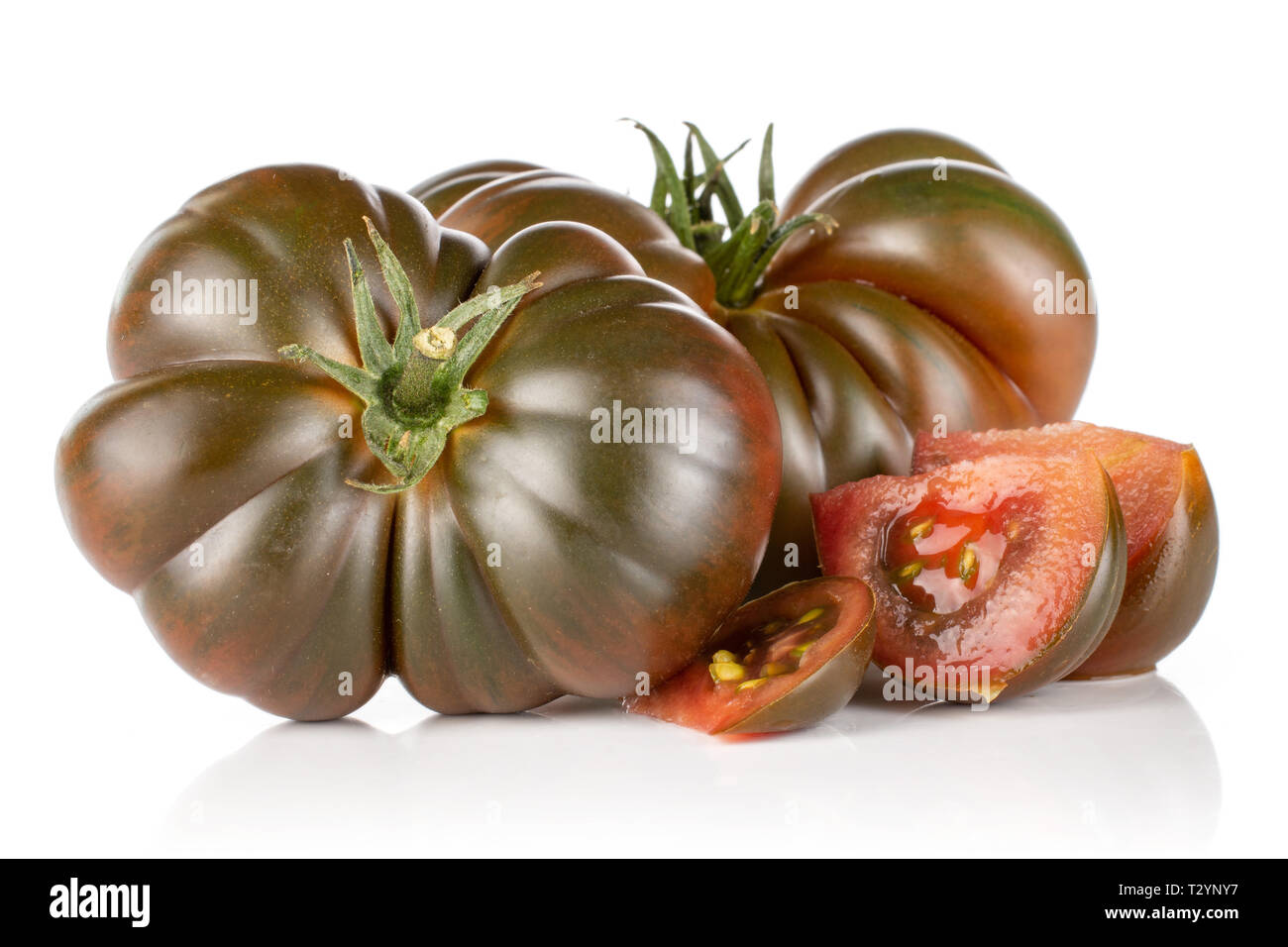 Group of two whole three slices of glossy fresh tomato primora isolated ...