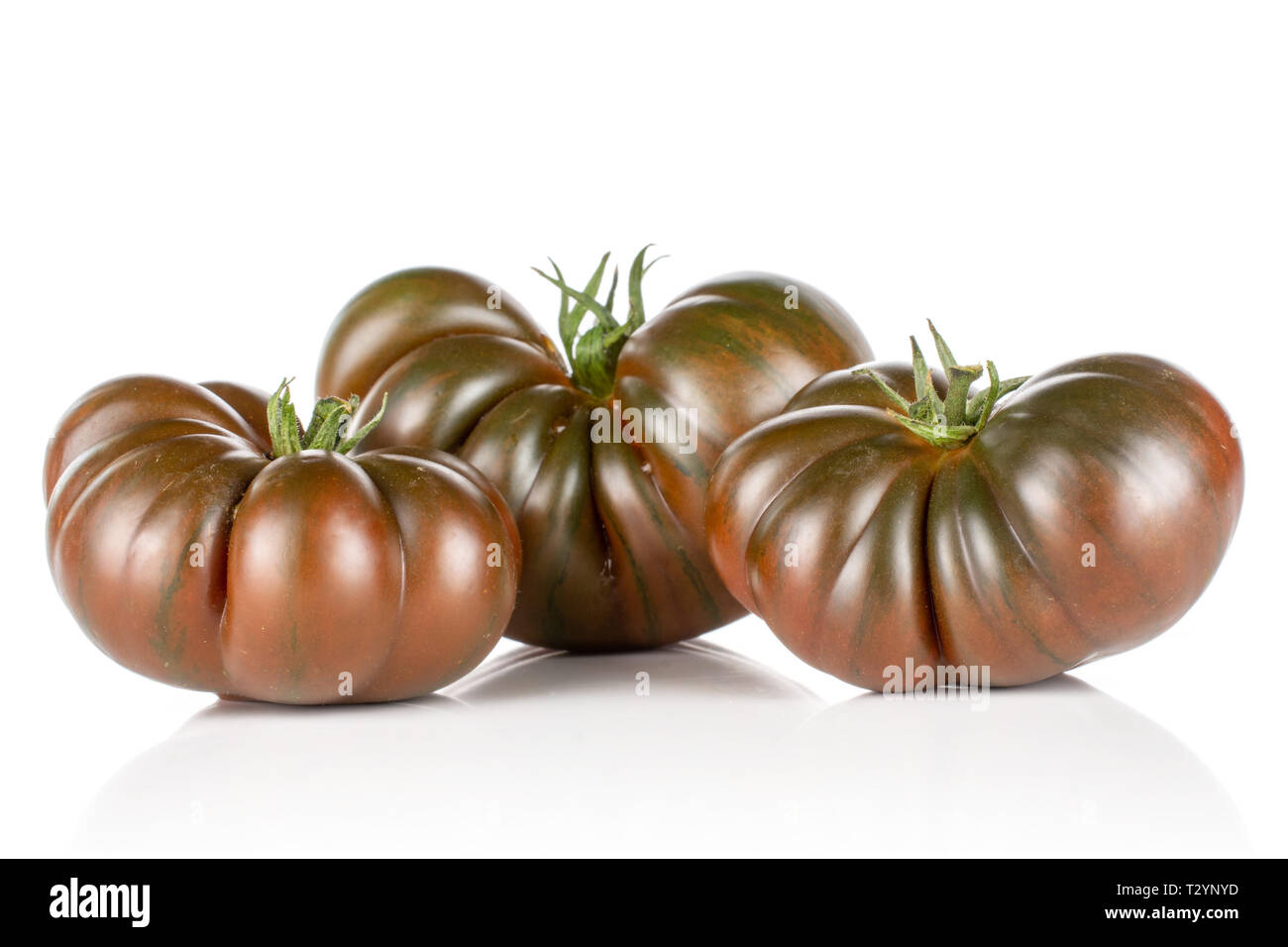 Group of three whole fresh tomato primora isolated on white background ...