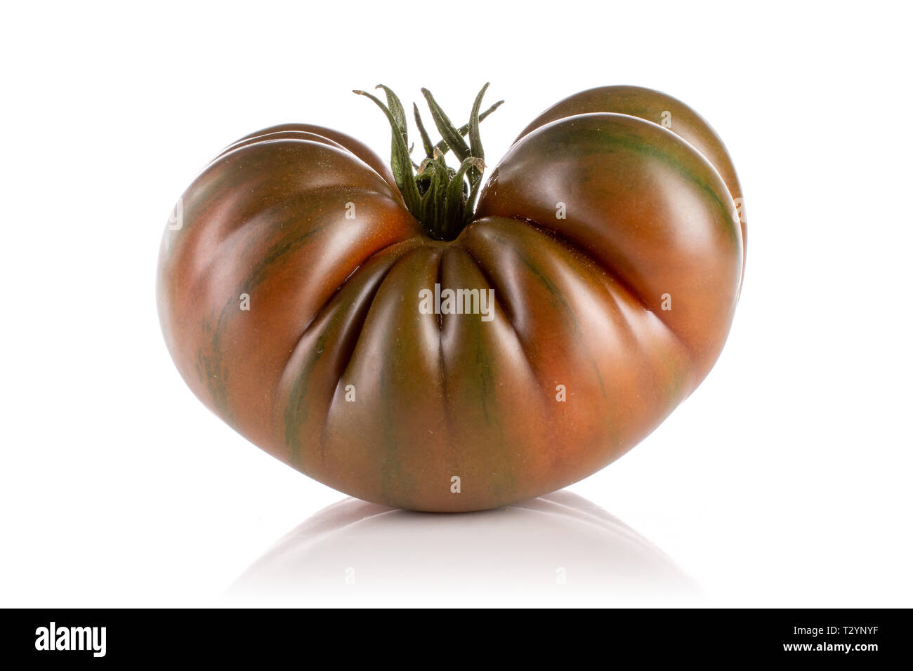 One whole meaty fresh tomato primora isolated on white background Stock ...