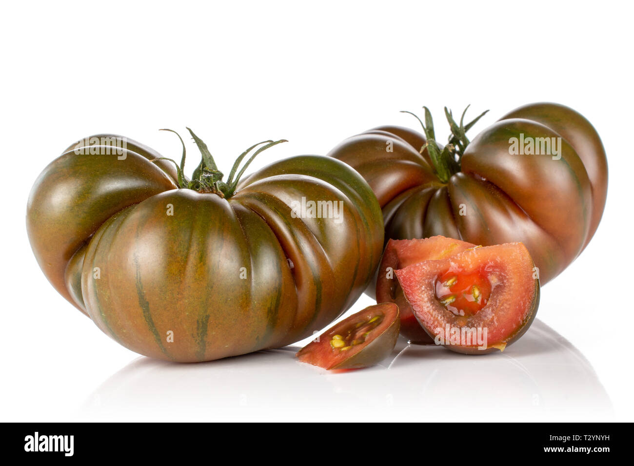Group of two whole three slices of meaty fresh tomato primora isolated ...