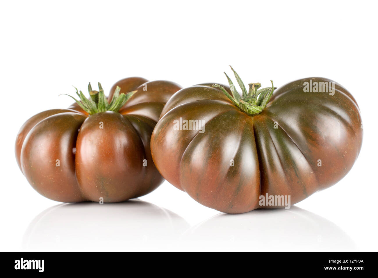 Group of two whole fresh tomato primora isolated on white background ...
