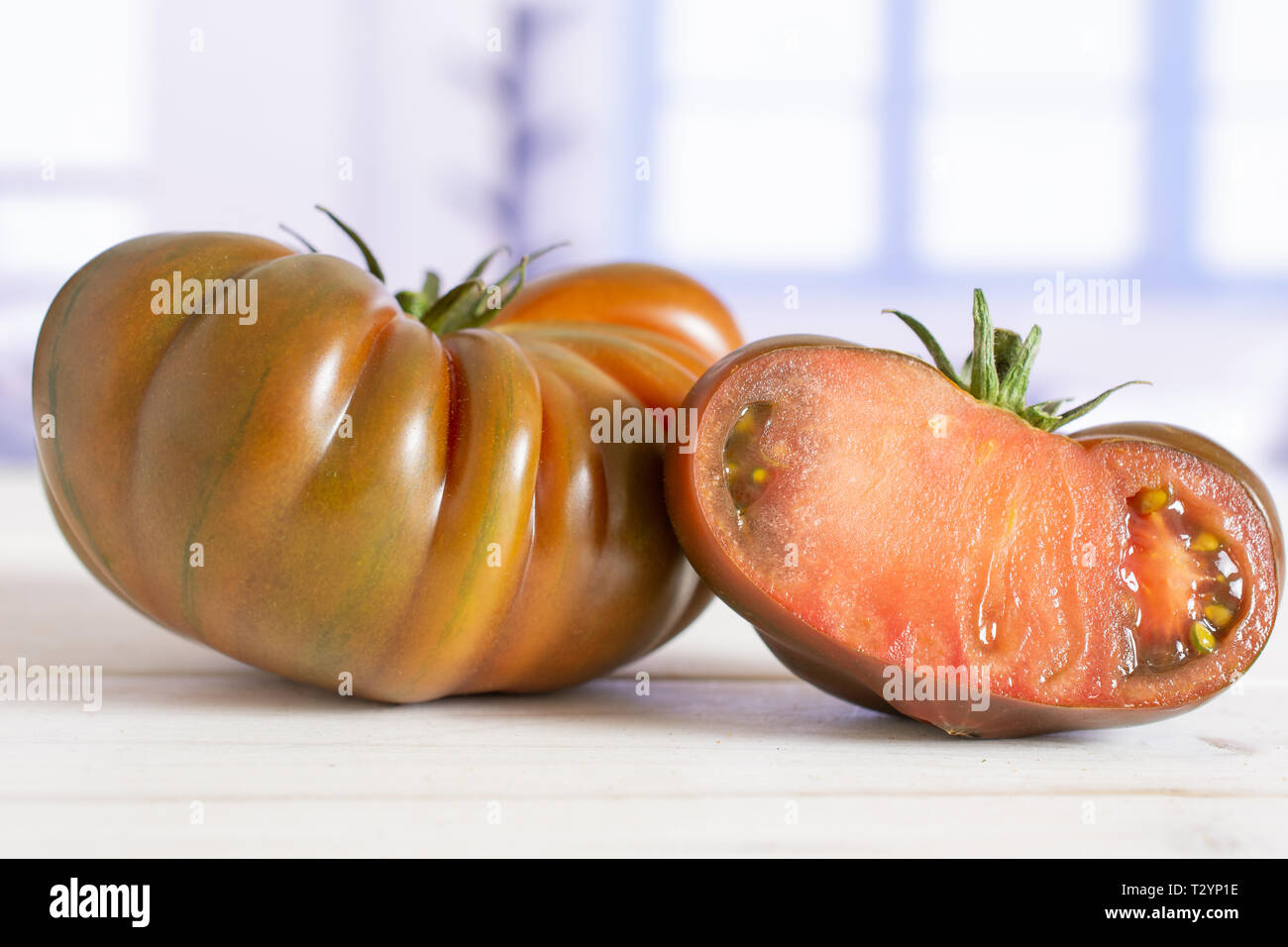 Group of one whole one half of fresh tomato primora with blue window in ...