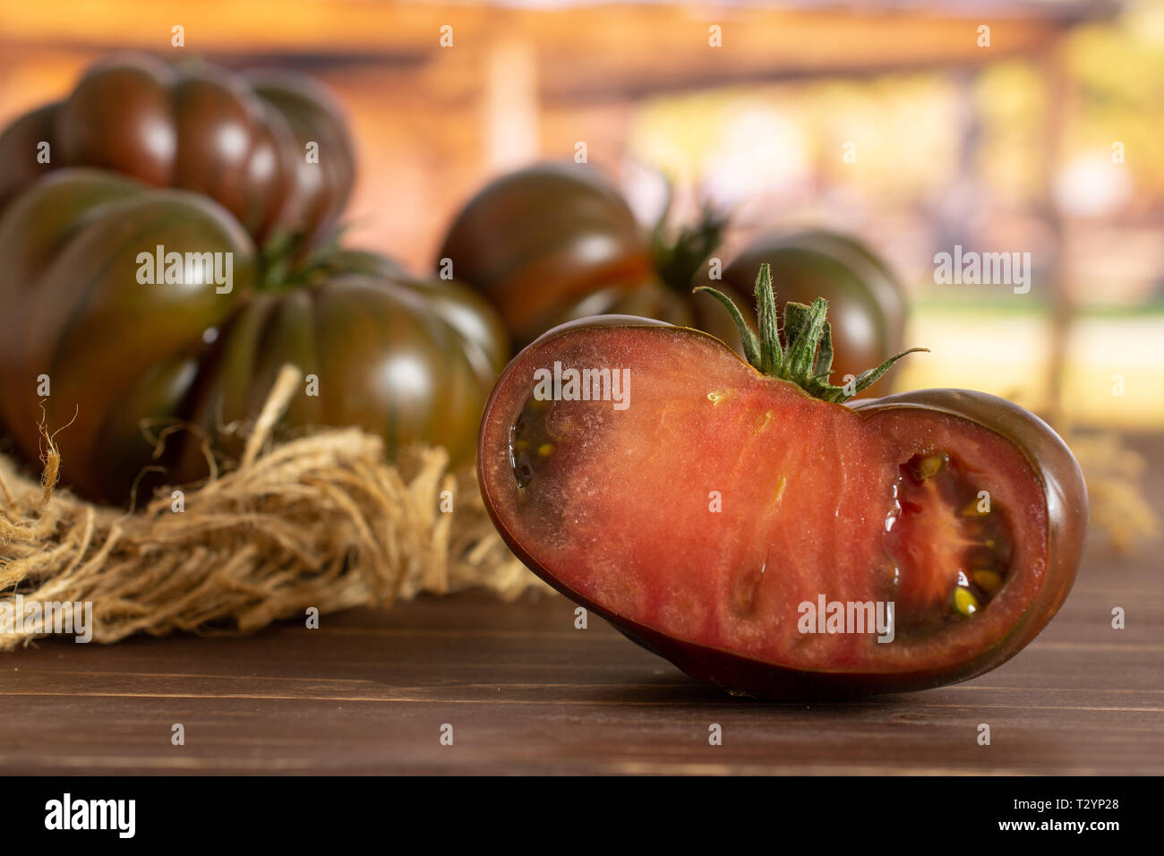 Lot of whole one half of fresh tomato primora on jute cloth in a yard ...
