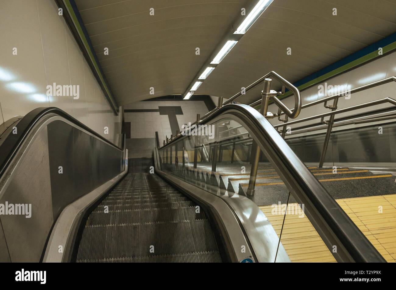 Stairway with handrail and escalator in a passageway in a stations of ...