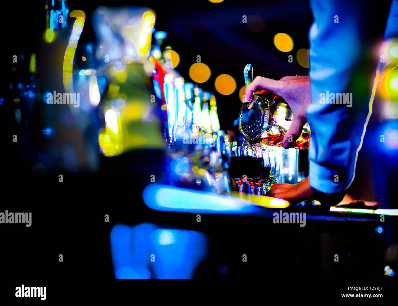 Bartender making alcohol cocktail at bar counter at nightclub, barman ...