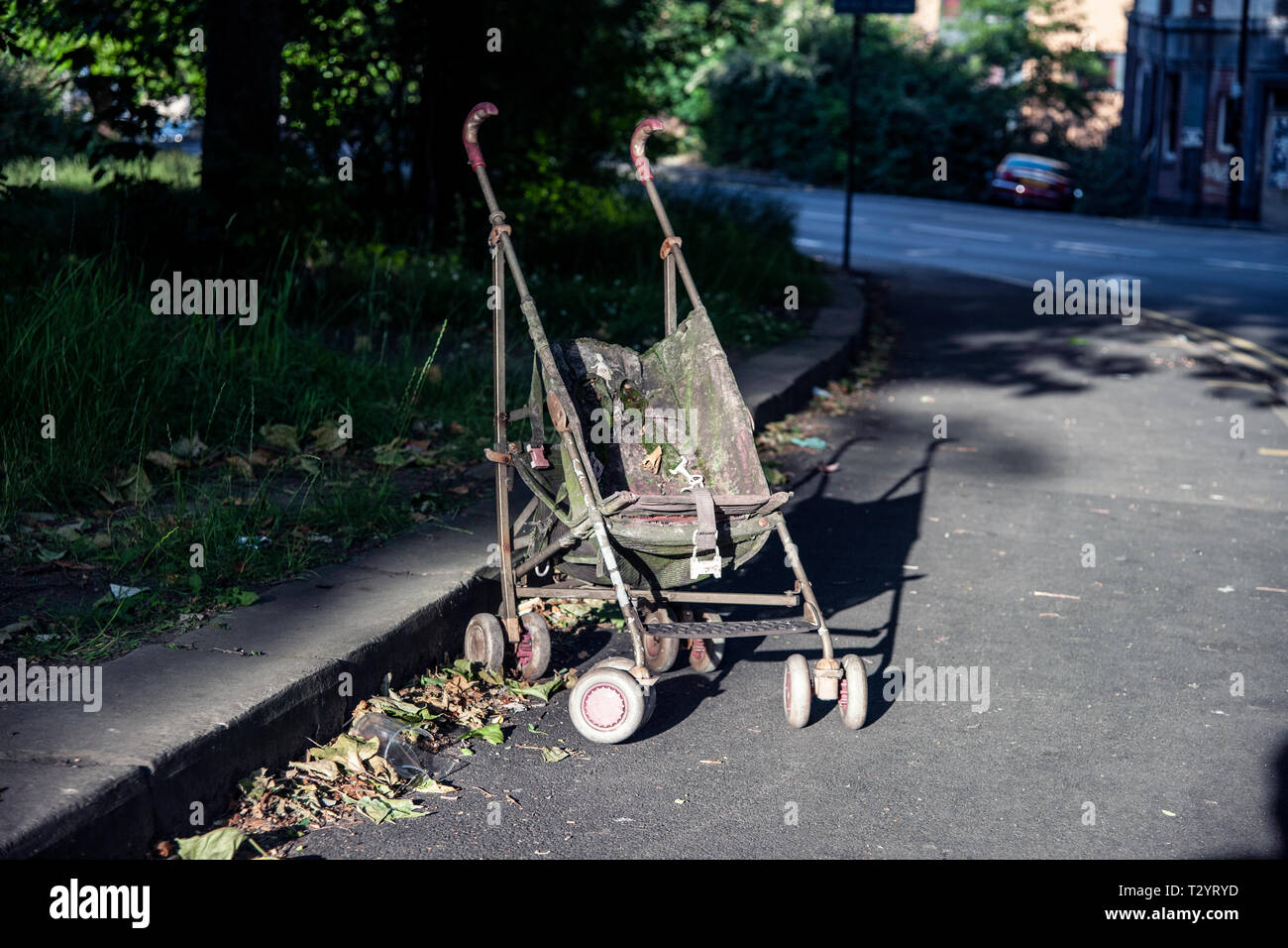 Worn out pushchair abandoned on a city street Stock Photo - Alamy