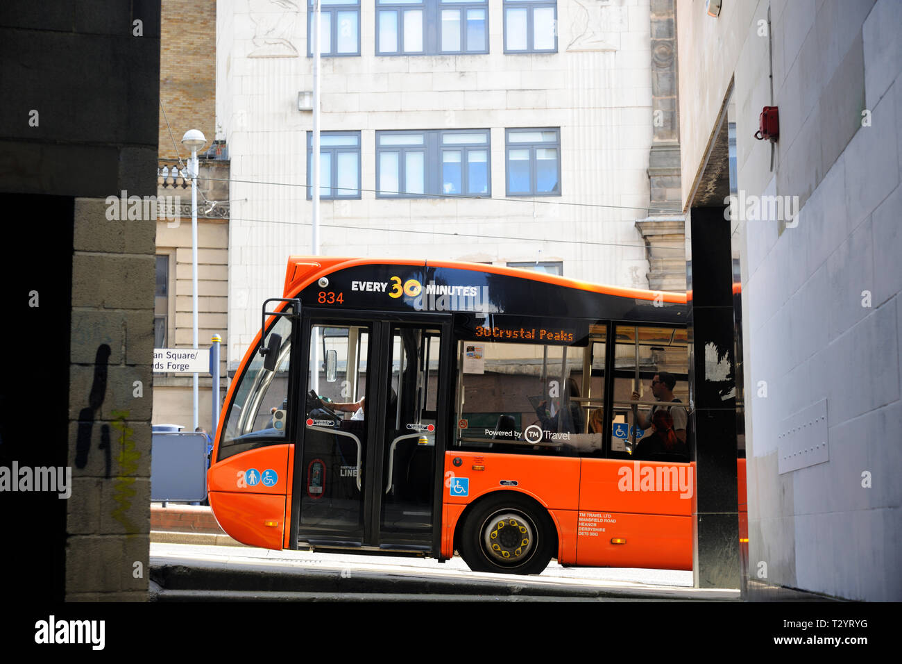 City bus with driver and passengers on board waits on Commercial Street ...